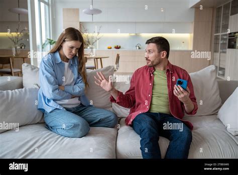 Offended Wife Suspecting Husband Of Unfaithfulness Man Hiding Phone