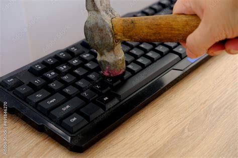 Closeup Computer Keyboard Iron Hammer Hits Keys With Force Breaks