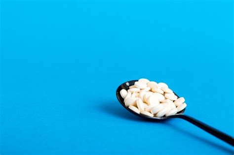 Premium Photo Heap Of White Pills On Colored Background Tablets