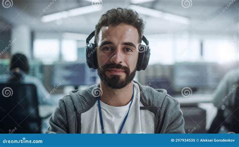 Office Portrait Of Happy It Programmer Wearing Headphones Working On Desktop Computer Male