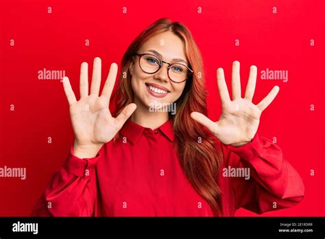 Young Beautiful Redhead Woman Wearing Casual Clothes And Glasses Over