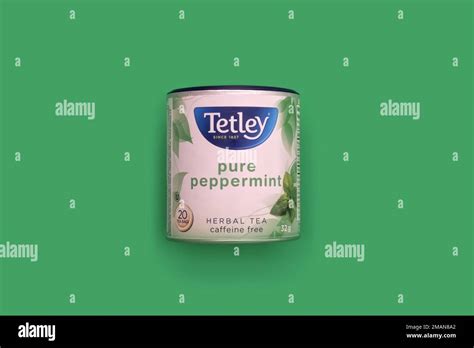 Tetley Caffeine Free Herbal Peppermint Tea Against A Green Background