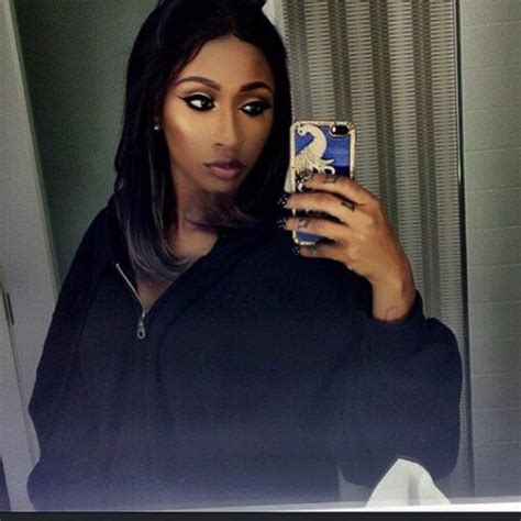 A Woman Taking A Selfie In Front Of A Bathroom Mirror With Her Cell Phone