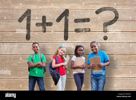 Composite Image Of Cute Pupils Smiling At Camera Stock Photo Alamy