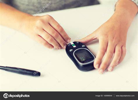 Close Up Of Woman Making Blood Test By Glucometer Stock Photo By Syda Productions 140999044