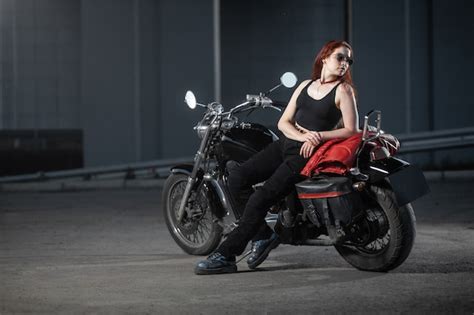 Premium Photo Girl Biker Sexually Posing On Motorcycle At Night City