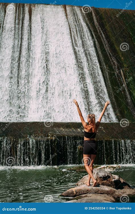 A Slender Tanned Girl With A Sports Figure Is Doing Yoga Exercises