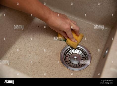 Efficiently Cleaning A Kitchen Sink With A Sponge For Enhanced Hygiene And Cleanliness Stock