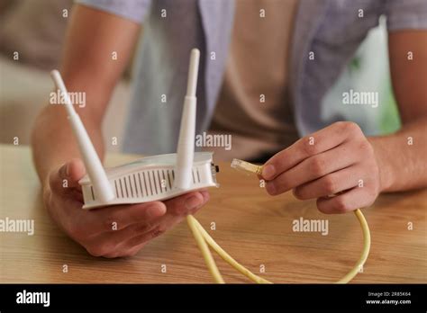 Hands Of Man Inserting Ethernet Cord In Wi Fi Router Stock Photo Alamy