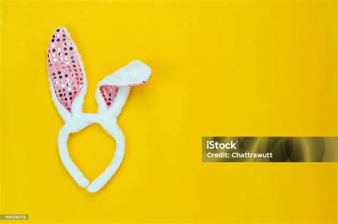 장식의 테이블 탑 뷰 샷 행복 한 부활절 휴일 배경 개념입니다 현대 소박한 노란 종이에 편평한 누워 아름 다운 의상 토끼 귀 템플릿 최대 모의 크리에이티브 디자인을 위한