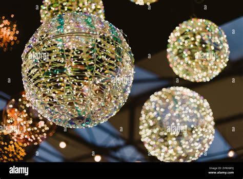 A Cluster Of Lights In The Shape Of Balls The Balls Are Lit Up And Are Hanging From The Ceiling