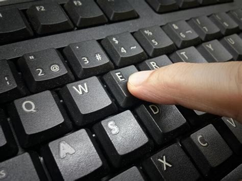 Premium Photo Cropped Hand Of Person Typing Letter E On Keyboard