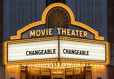 Iconic Illuminated Movie Theater Marquee And Blank Sign Board Stock