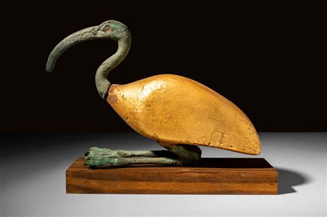 At Auction Egyptian Gilded Wood And Bronze Ibis Statue