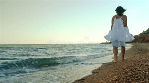 A Girl Walks Barefoot Along The Sea Coast Stock Video Video Of