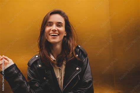 Simpering Young Brunette Woman With A Coy Smile As She Flirts Over A