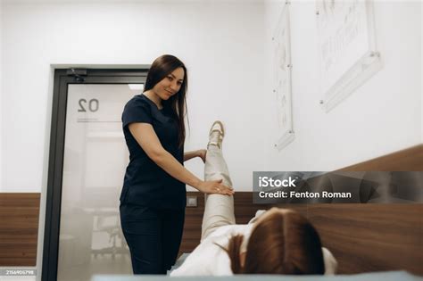 Neurological Examination The Neurologist Testing Reflexes On A Female
