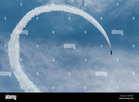 Two Airplanes Fly In Parallel Describing A White Parabolic Trajectory