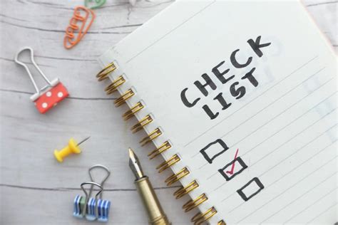 Premium Photo Check List On Notepad With Pen On Table