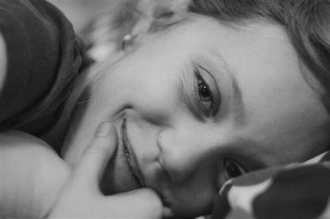 Premium Photo Close Up Portrait Of Girl Smiling While Lying On Bed