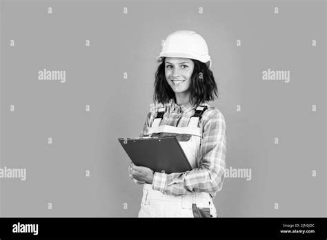 Foreman Inspector Girl In Checkered Shirt And Protective Hard Hat