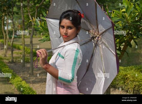 Teenage Indian Bengali Girl Wearing White Cotton Salwar Holding An