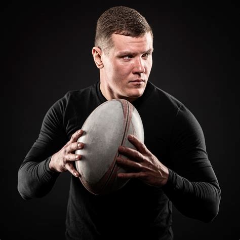 Premium Photo Athletic Male Rugby Player Posing While Holding Ball