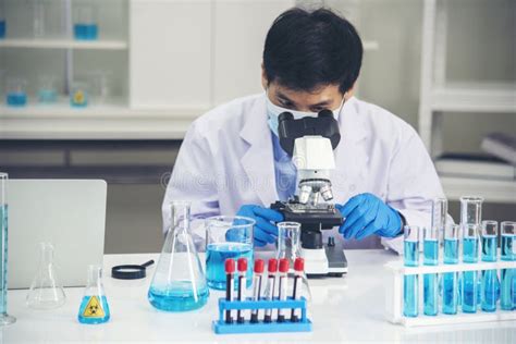 Scientist Man Look Into Microscope Research In Science Laboratory