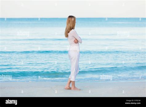 Beautiful Blonde Woman Relax Alone At The Beach In Summer Stock Photo