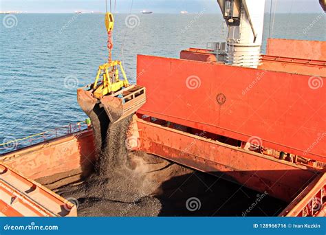 Loading Coal From Cargo Barges Onto A Bulk Carrier Using Ship Cranes