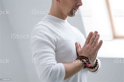 흰색 배경에 흰 옷을 입는 남자 그의 손이 가슴에 접혀 있습니다 명상과 기도 요가 건강한 생활방식에 대한 스톡 사진 및 기타