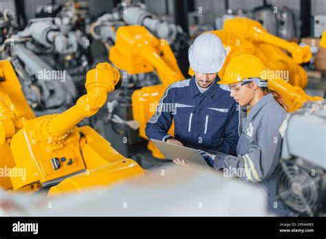 Engineer Team Working Together Inspection Quality Robot Arm In Robot
