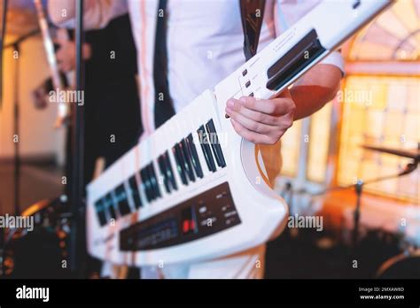 Concert View Of A Keytar Synthesizer Player With Vocalist And Musical