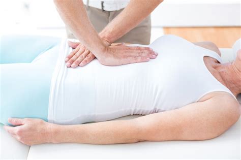 Premium Photo Physiotherapist Examining His Patients Stomach