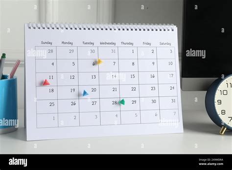 Timetable Calendar With Marked Dates Alarm Clock And Stationery On