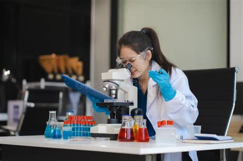 Science And Medicine Scientist Analyzing And Dropping A Sample Into A