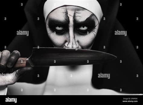 Scary Devilish Nun With Knife On Black Background Closeup Halloween