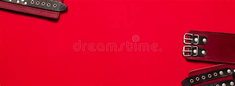 Red Color Banner With Black Leather Bracers And Metal Rivets For