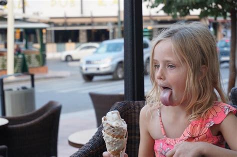 Premium Photo Close Up Of Girl Eating Ice Cream In City