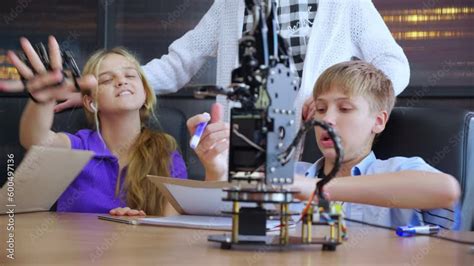 Caucasian Two Teenager Babes Learning Robotic Arm In Classroom Together At Babe Babe And