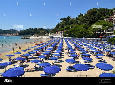 Elevated View Of A Sandy Beach With Rows Of Sun Umbrellas People