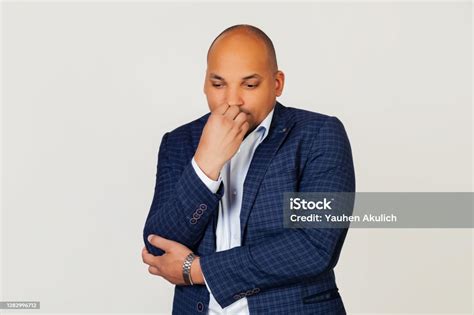 화가 난 젊은 아프리카 계 미국인 사업가 남자의 초상화 그의 손톱을 물고 입술에 손으로 긴장과 긴장 보인다 불안 문제 회색 배경에 서 있습니다 남자 사업가에 대한 스톡 사진
