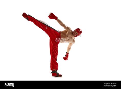 Leg Kick Young Professional Kickboxer Wearing Helmet And Boxing Gloves