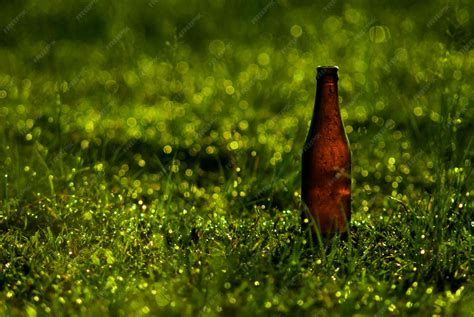 Premium Photo Bottle In Green Grass