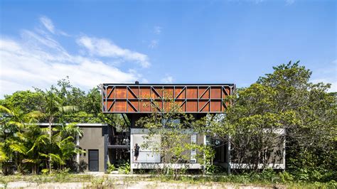 Laurent Troost Architects Folds Weathered Steel Roof Over Concrete