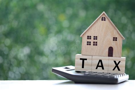 Fixed Rate Model House On Calculator With Stack Of Coins Money On