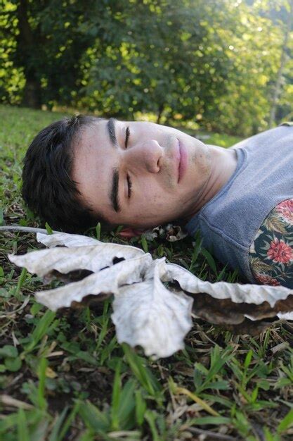 Premium Photo Close Up Of Man Sleeping By Dried Leaf On Field