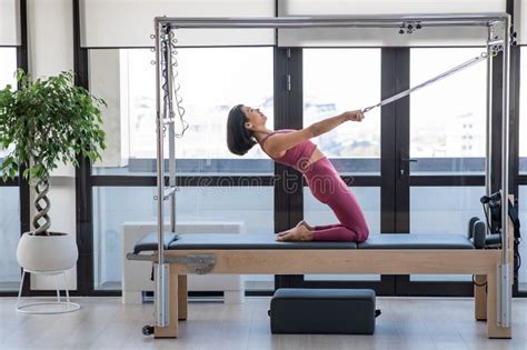 Asian Woman Doing Pilates On Reformer Machine Stock Image Image Of