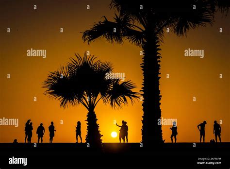 Silhouettes Of People Standing At Maspalomas Lighthouse Deck And
