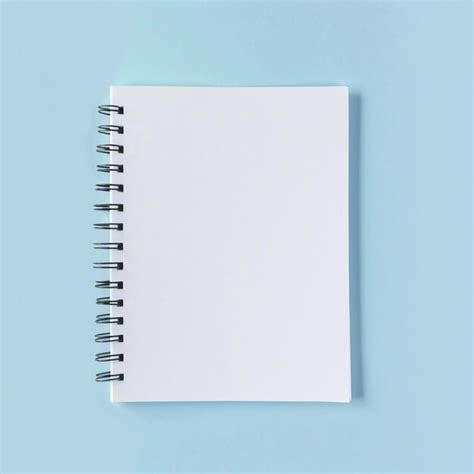 A Spiral Bound Notebook Is Open On A Blue Background Premium Ai